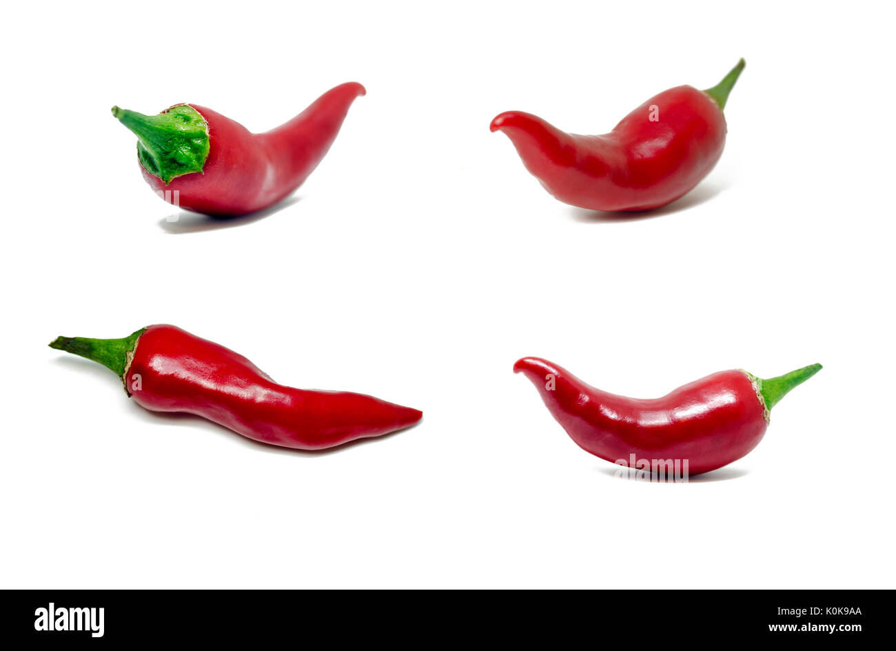 Four red chili isolated on white Stock Photo - Alamy