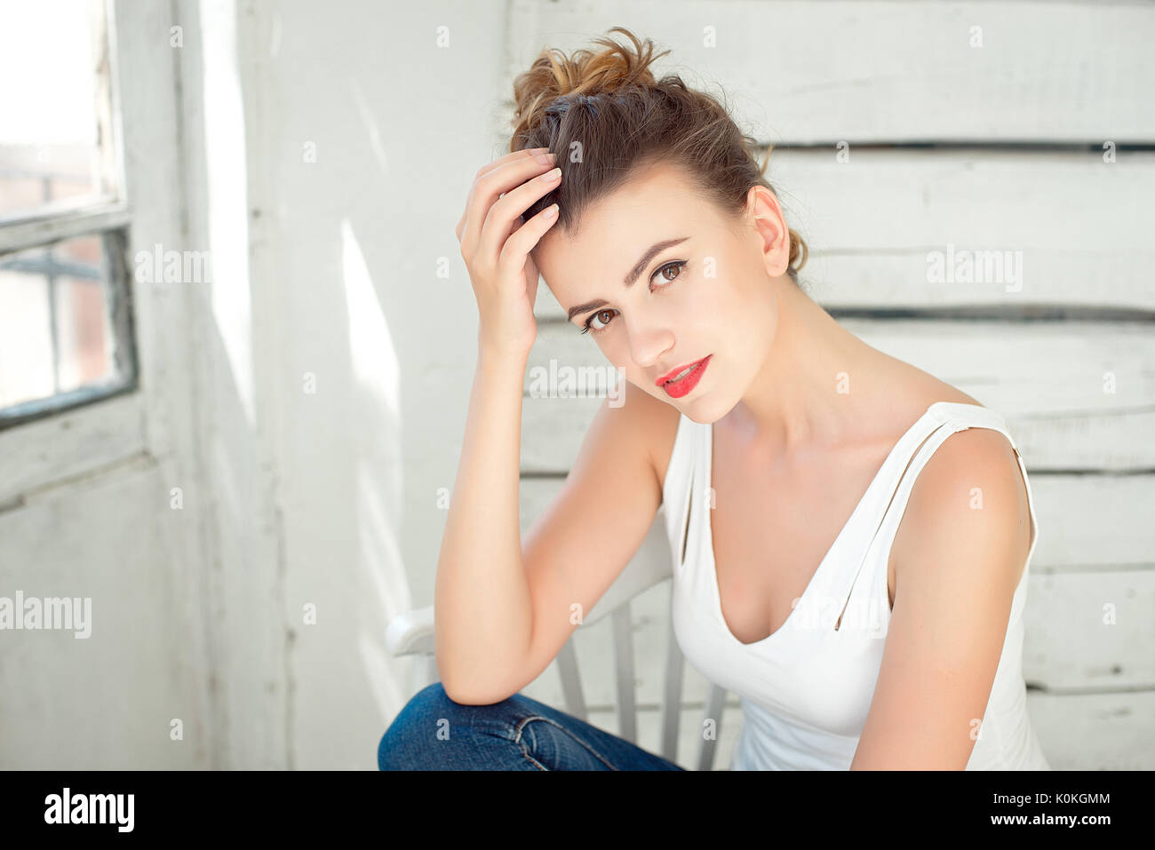 Young beautiful brunette woman smiles in Think pose on background Stock ...