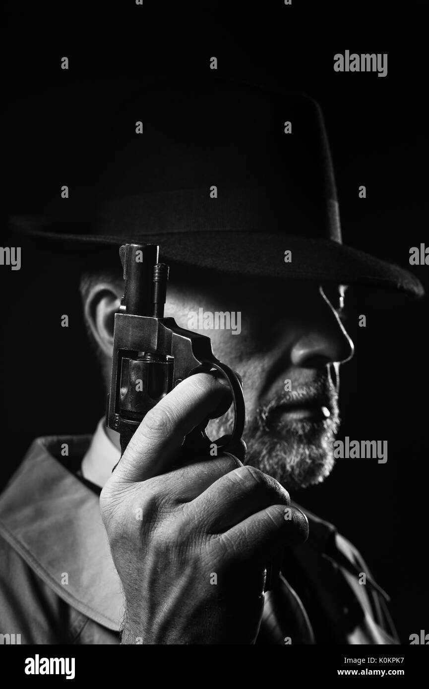 Wearing a hat and a trench coat Black and White Stock Photos & Images ...