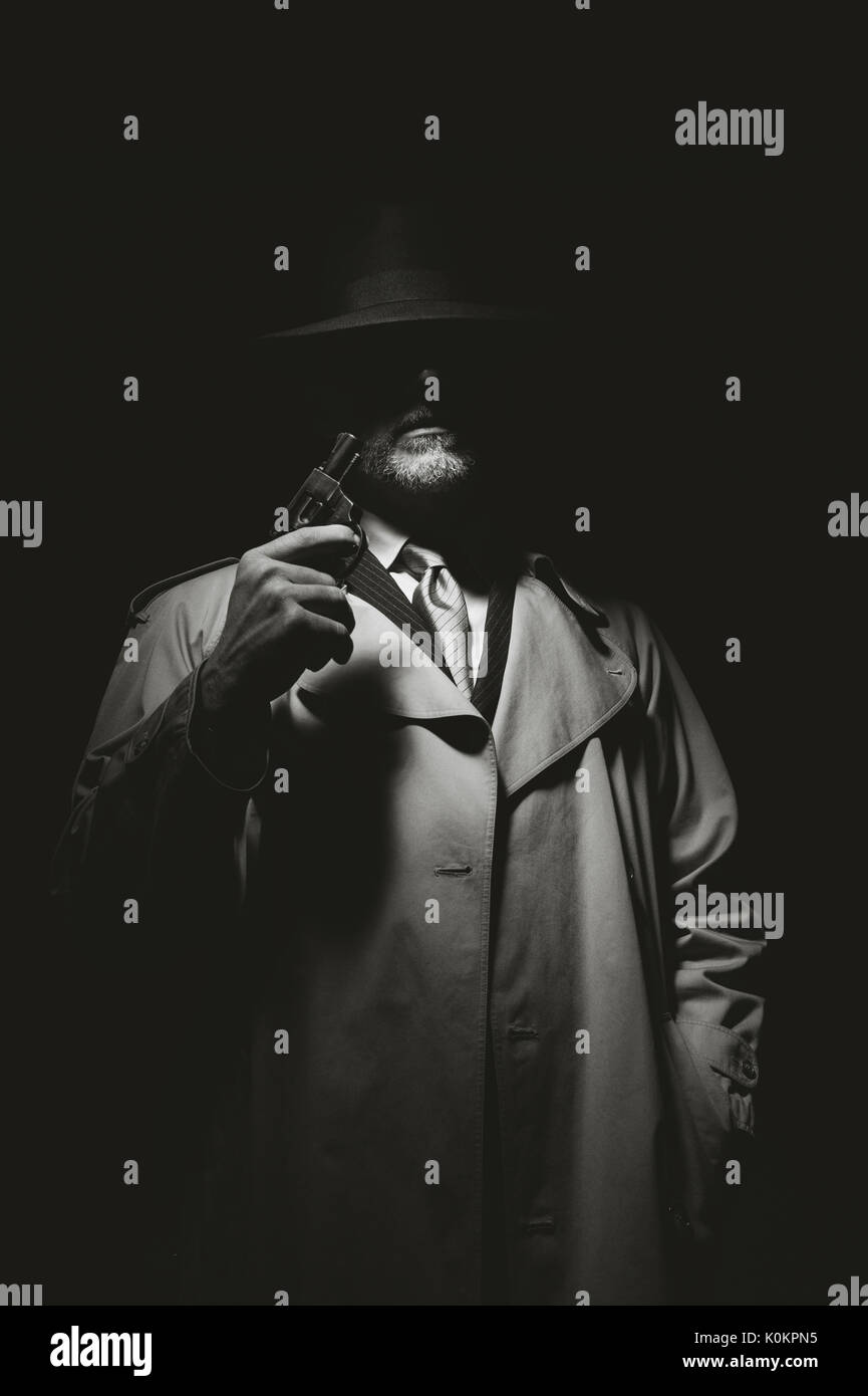 Undercover agent holding a pistol in the dark, 1950s noir film ...