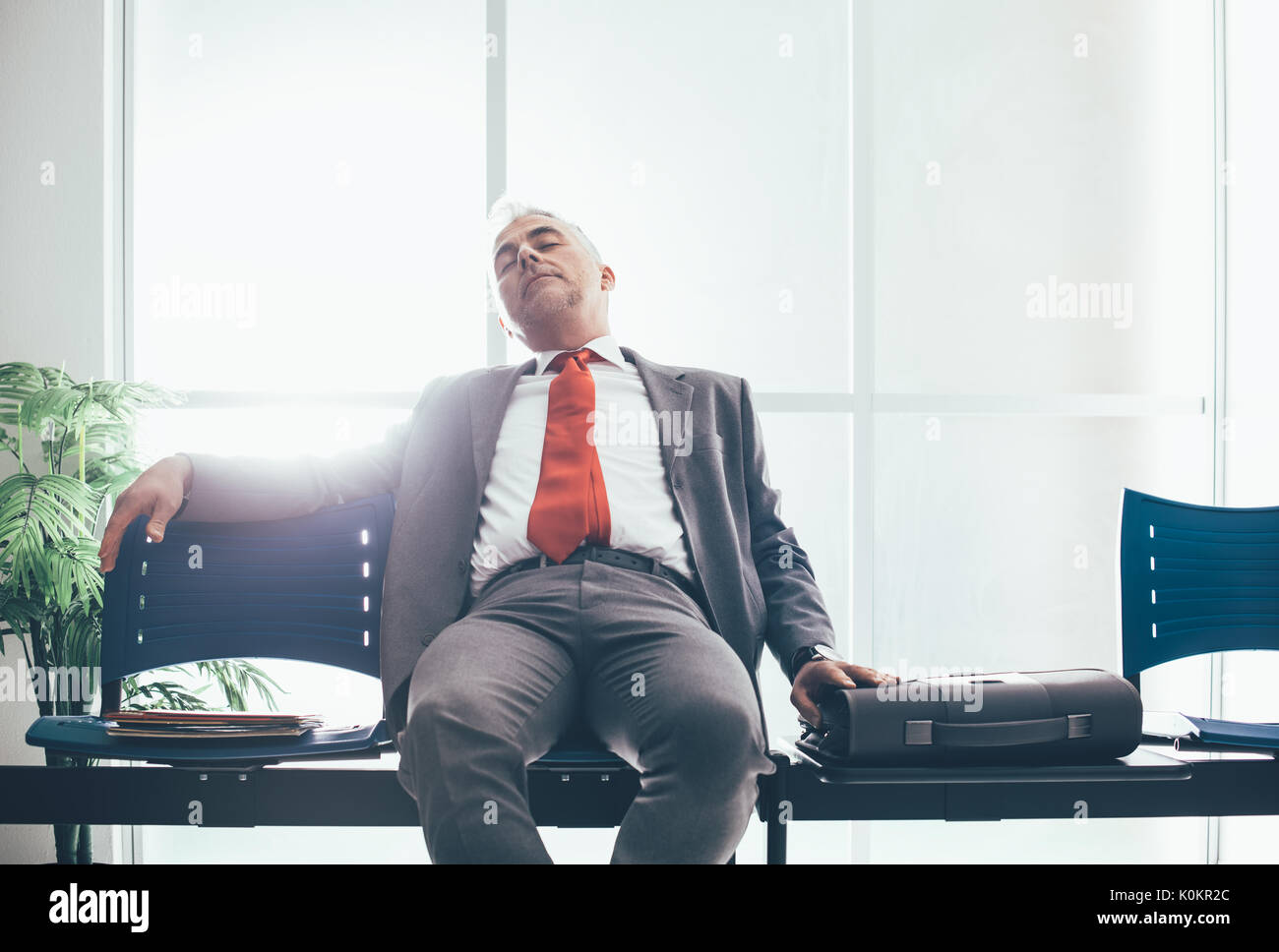 Man sleeping in waiting room hi-res stock photography and images - Alamy