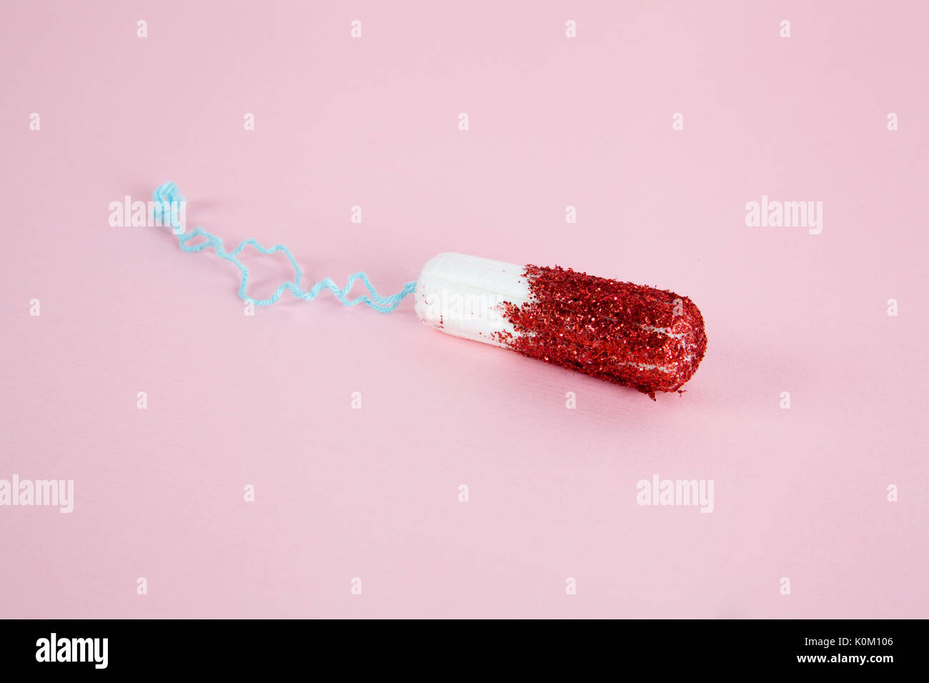 A hygienic tampon with red glitters instead of blood. Minimal color ...