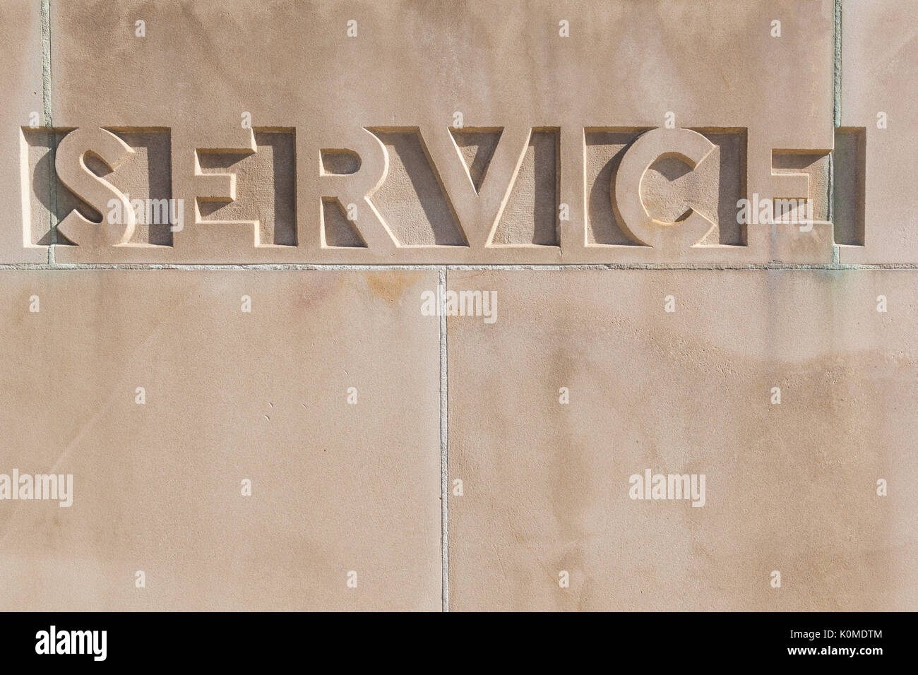 The word SERVICE carved in concrete with copy space Stock Photo - Alamy