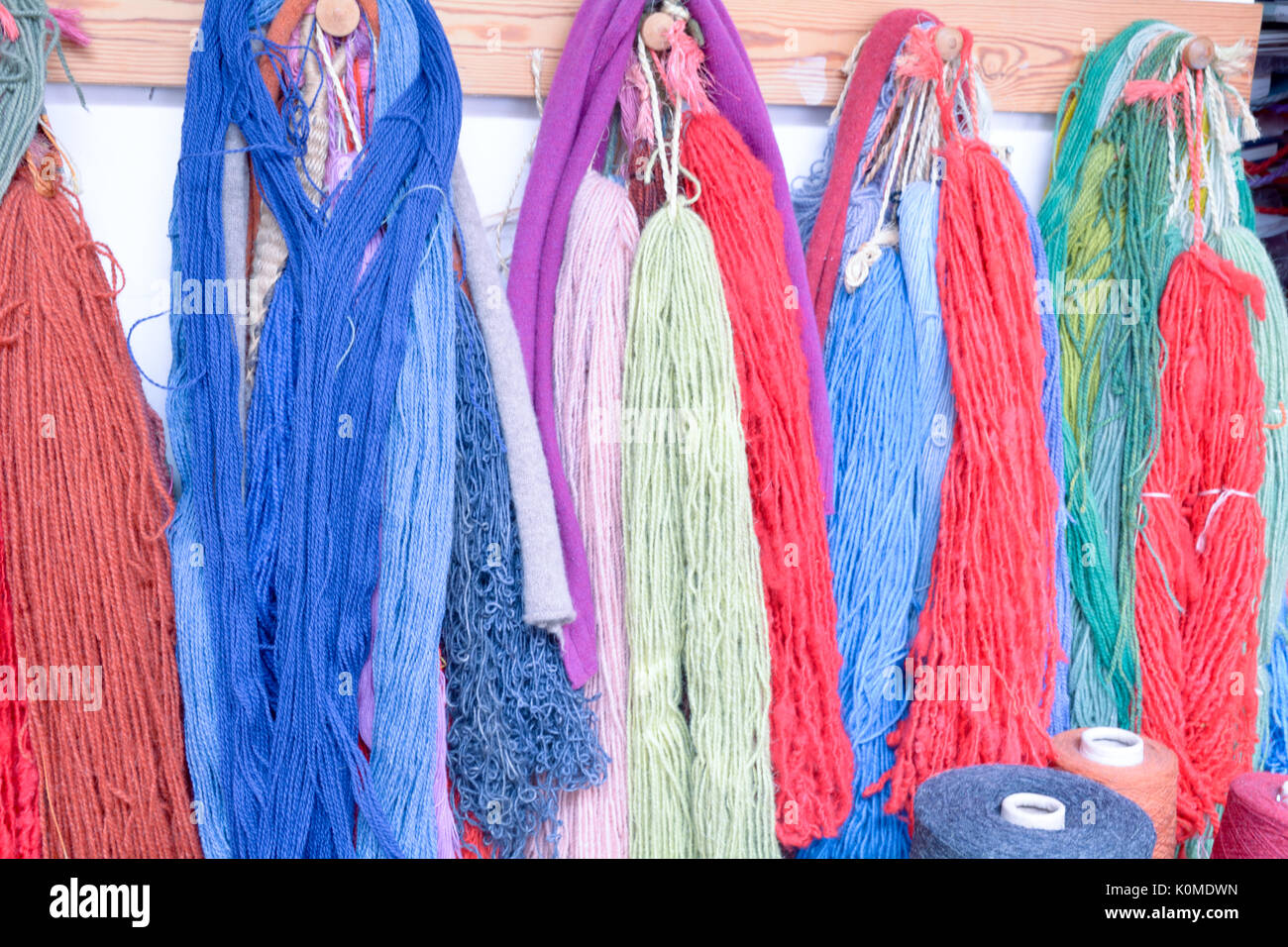 Hand dyed and handspun wool with a range of vibrant colours hanging on ...