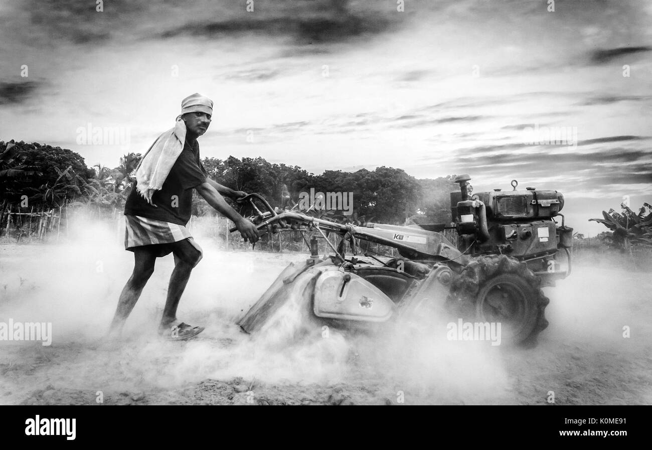 Indian farmer ploughing field tractor hi-res stock photography and ...