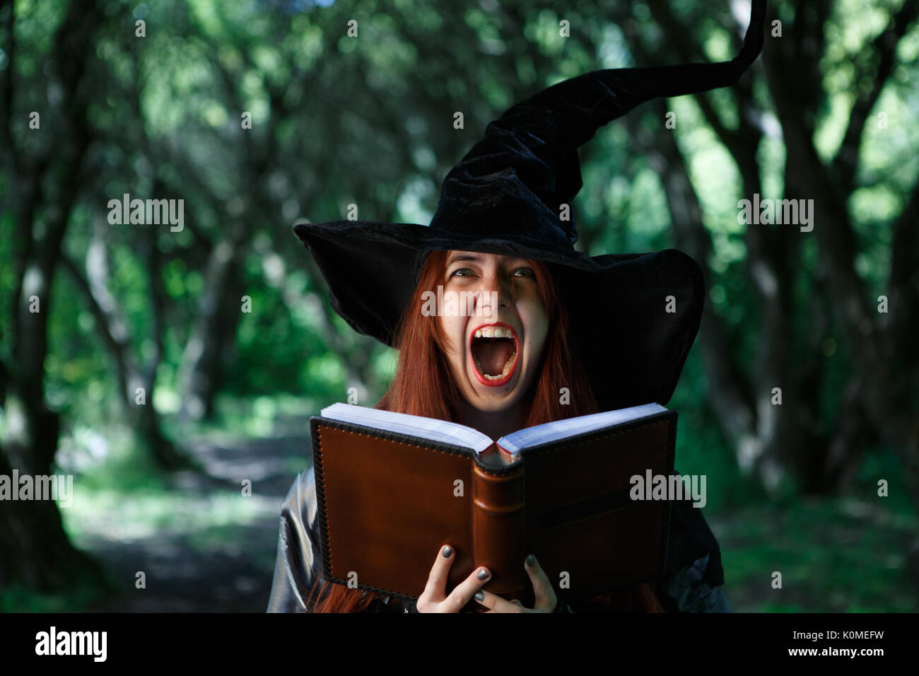Portrait of young screaming witch Stock Photo - Alamy