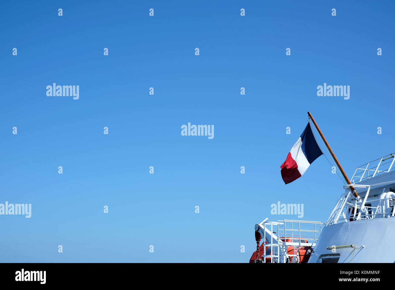 Rear of a passenger ferry showing a French tricolour flag against a ...