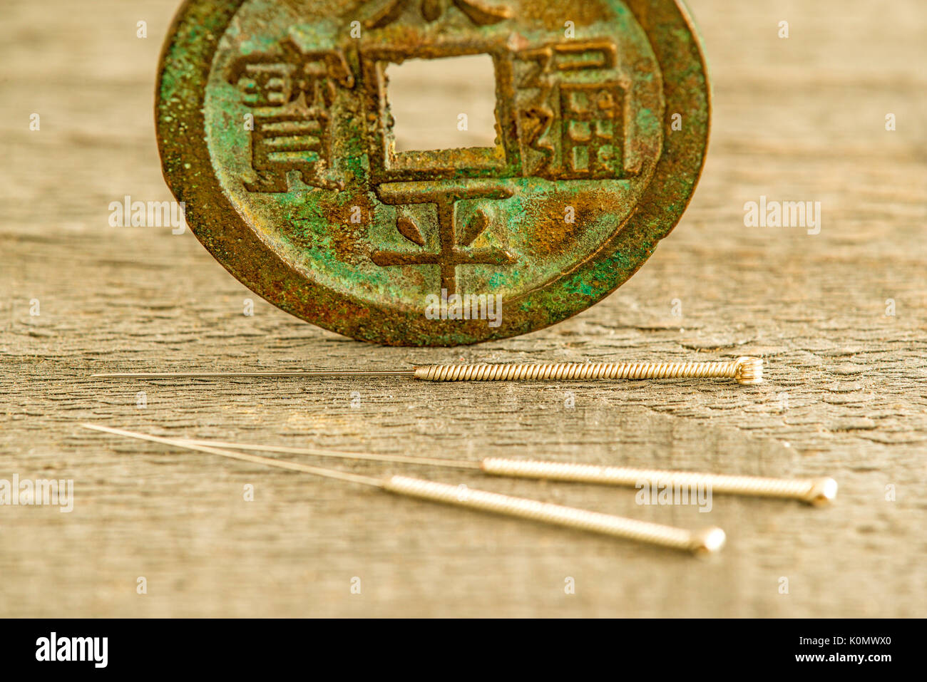 acupuncture needles on antique Chinese coin Stock Photo - Alamy