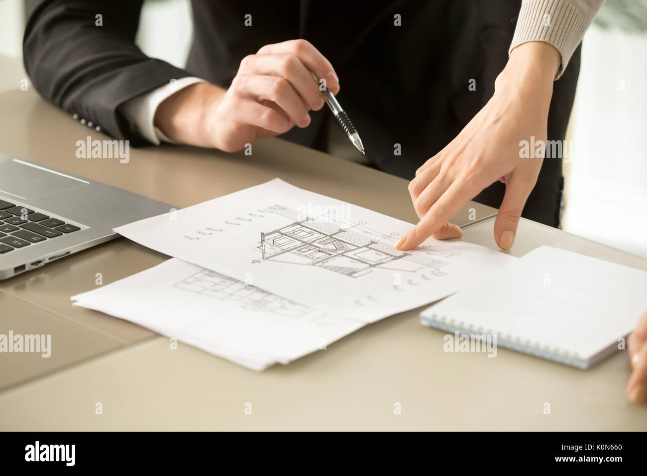 Architects discussing two-story house building plan, property ap Stock ...