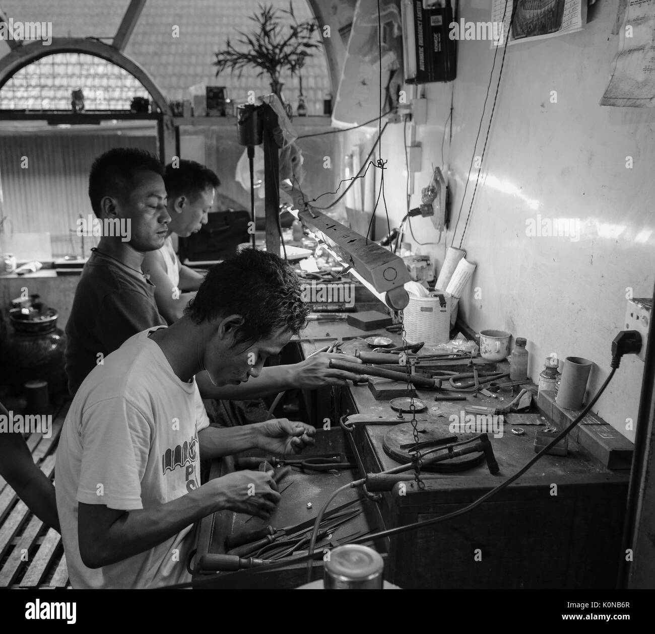 Bagan, Myanmar - Feb 19, 2016. Burmese men working at a jewellery shop ...