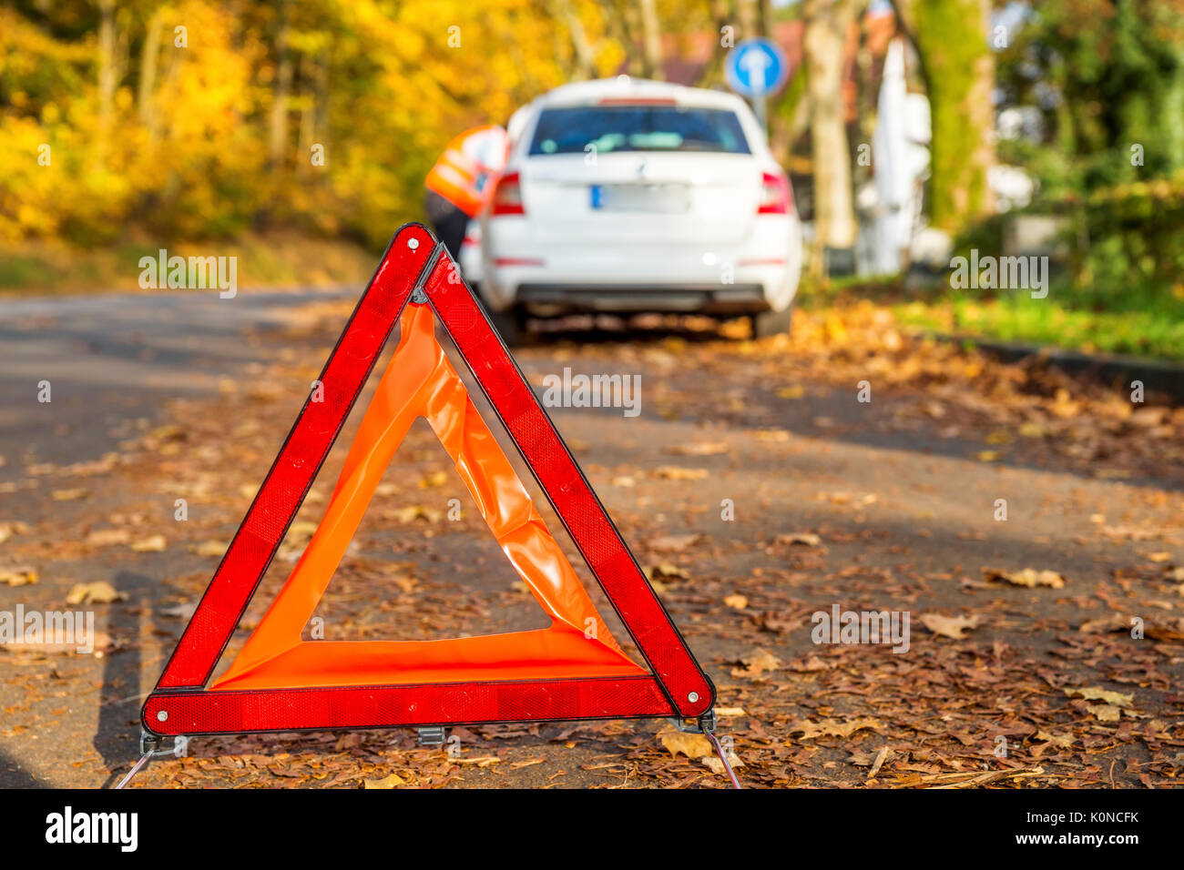 Warning triangle on the road by a car breakdown Stock Photo - Alamy