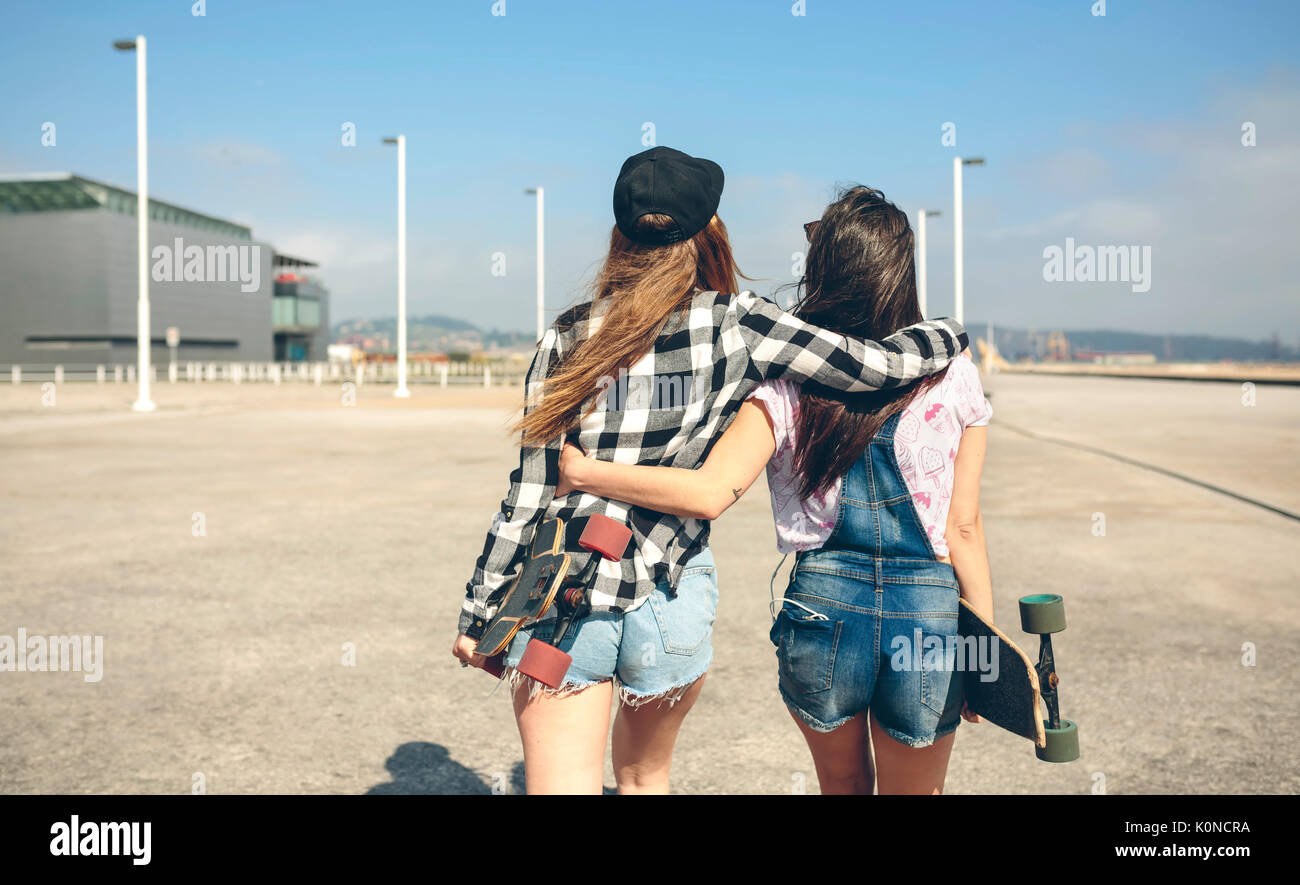 Two women only walking arm and arm hi-res stock photography and images ...