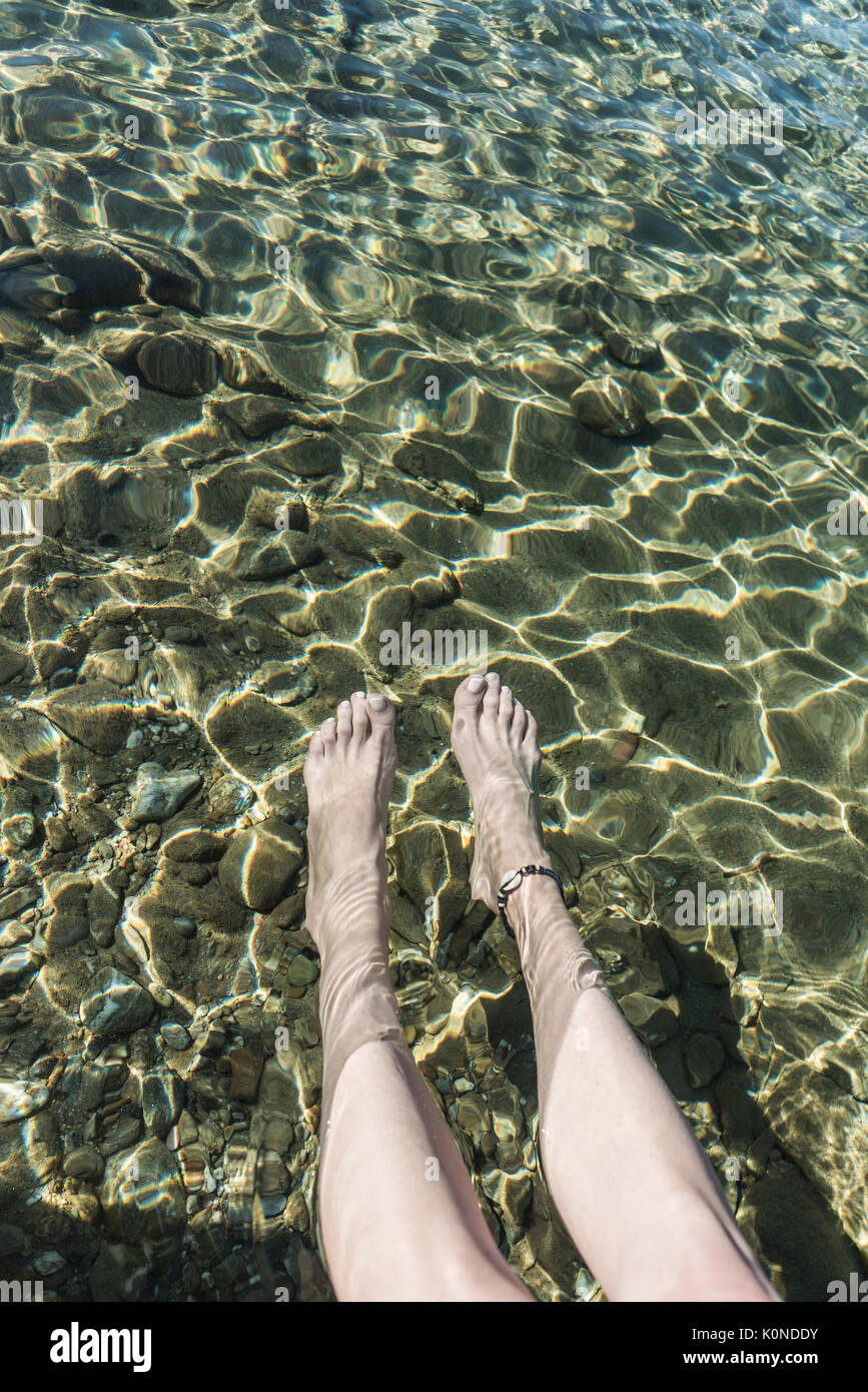 Woman's legs in shallow seawater Stock Photo - Alamy