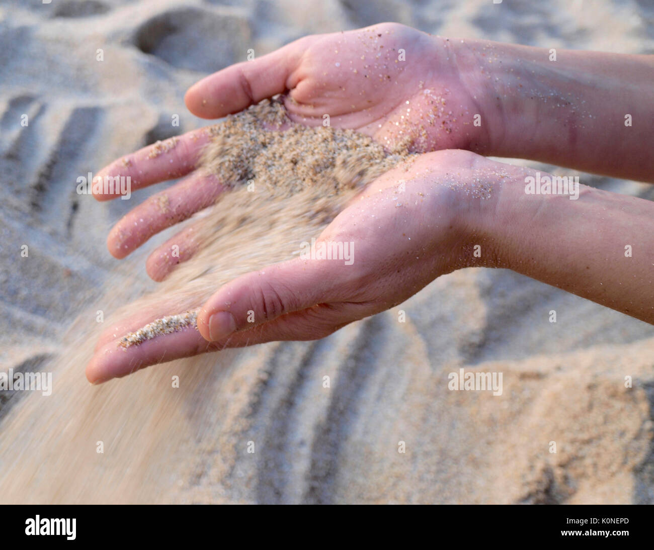sand falling from hands Stock Photo - Alamy