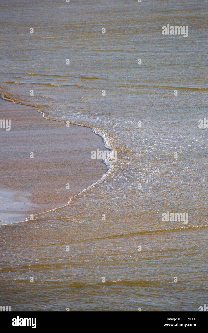 Incoming tide on a beach Stock Photo - Alamy