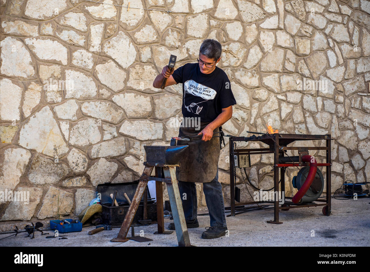 Blacksmith demonstrates his skills at a market Stock Photo - Alamy