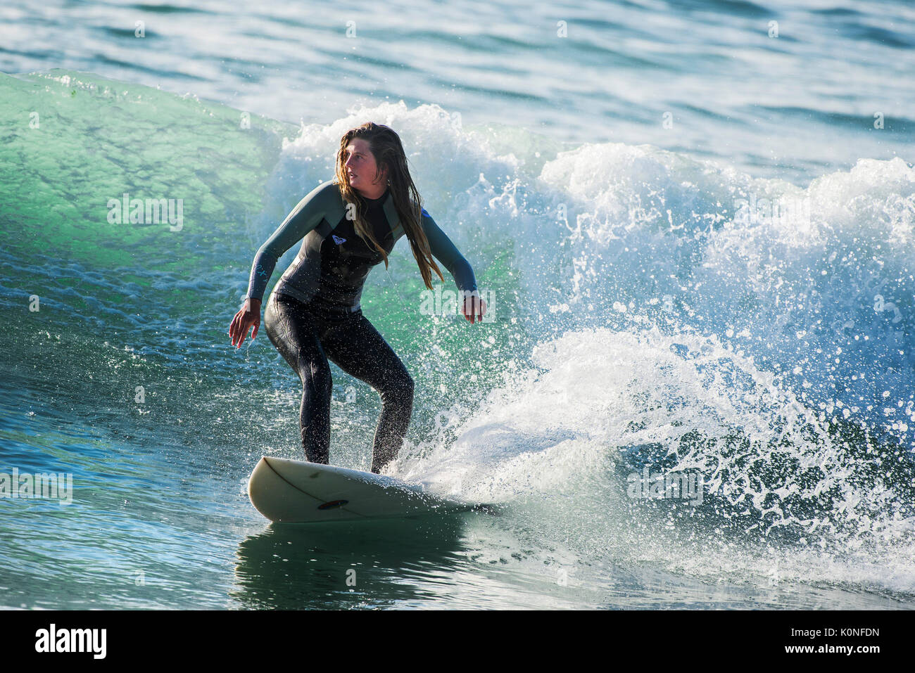 female surfer surfing wave riding a wave Fistral beach in Newquay Stock ...