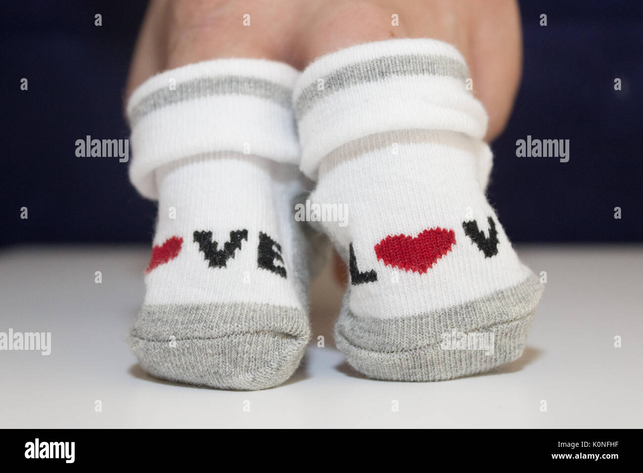 hands holding small baby socks Stock Photo - Alamy