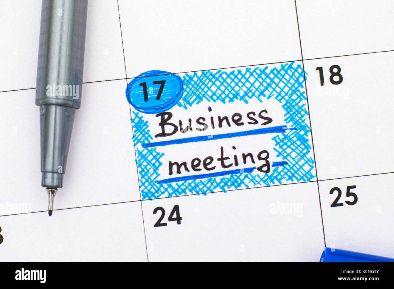 Reminder Business meeting in calendar with blue pen Stock Photo - Alamy