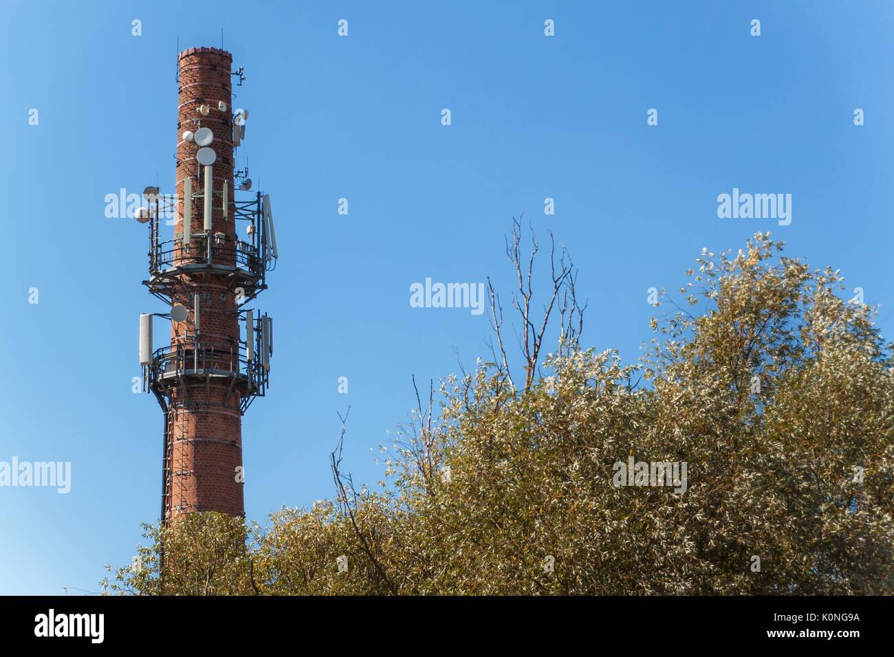 Telecommunication antennas on an old brick chimney. Industrial concept ...