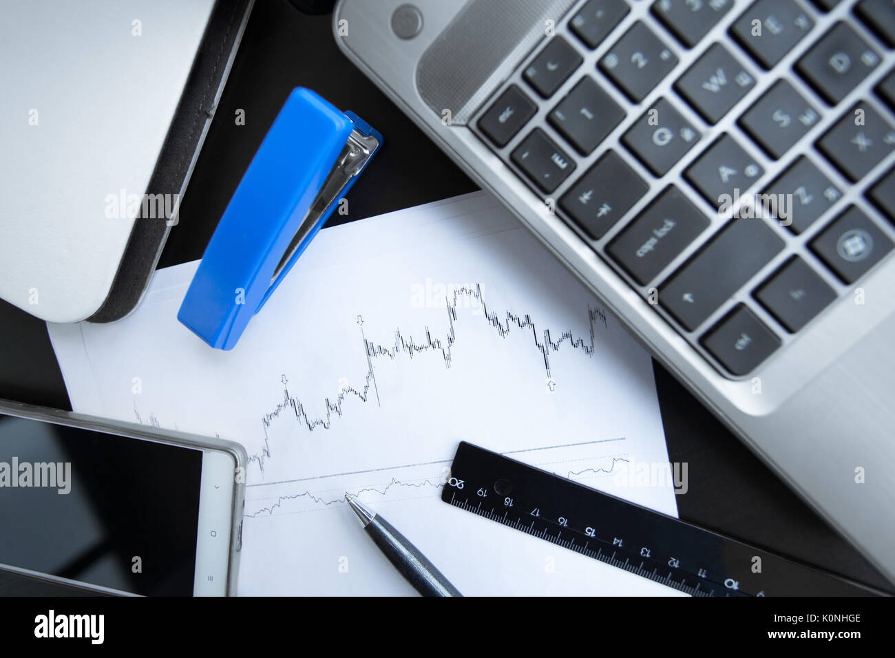 Investment charts with laptop. Accounting. Studio shot Stock Photo - Alamy