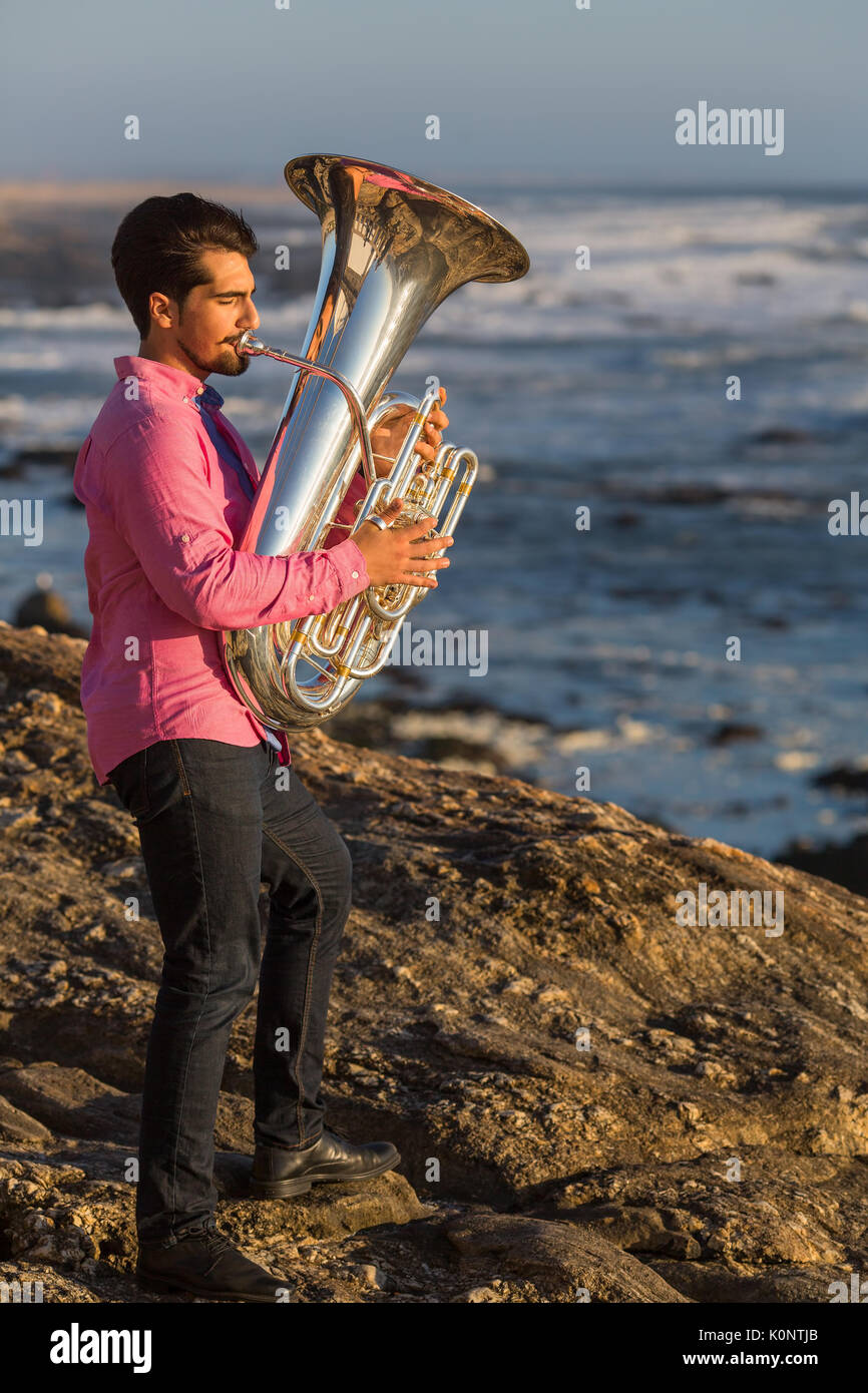 Musician play to musical instrument Tuba on romantic sea shore Stock ...