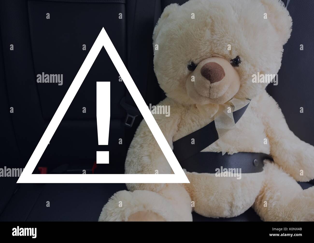 Digital composite of Caution sign icon against teddy bear in the car ...
