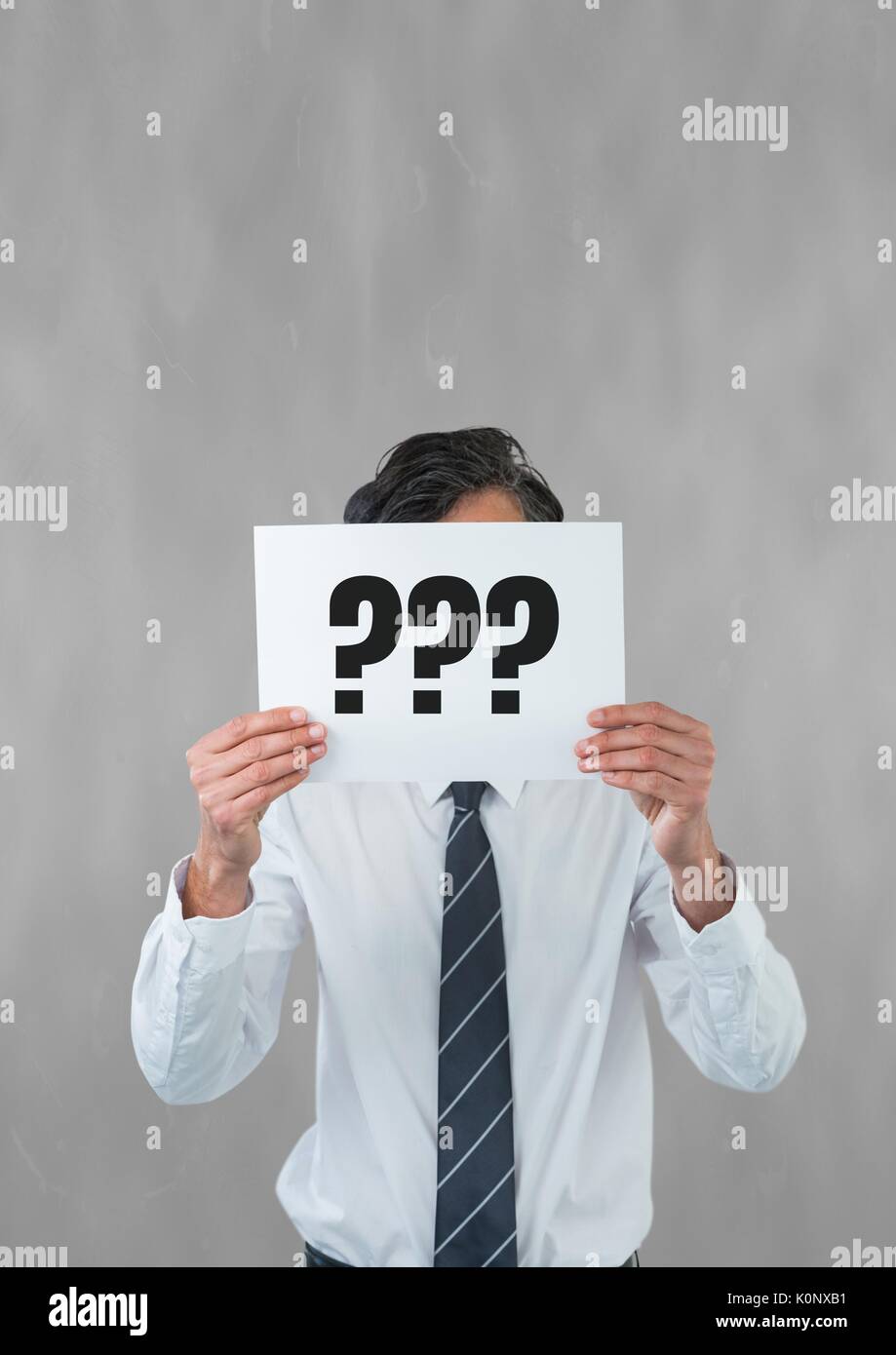 Digital composite of Business man holding a card with question marks ...