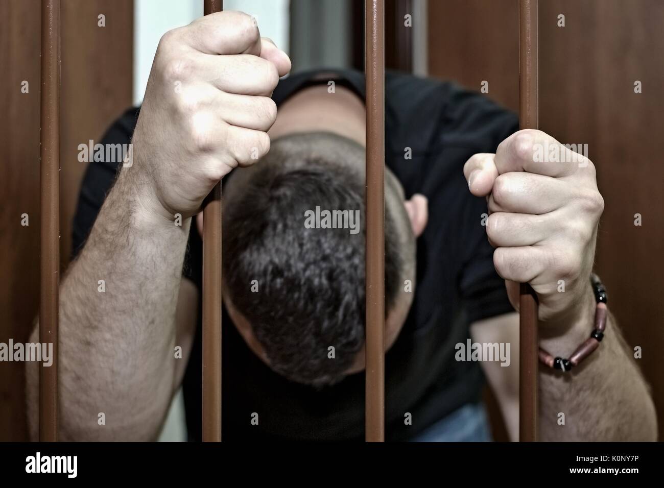Prisoner behind bars hi-res stock photography and images - Alamy