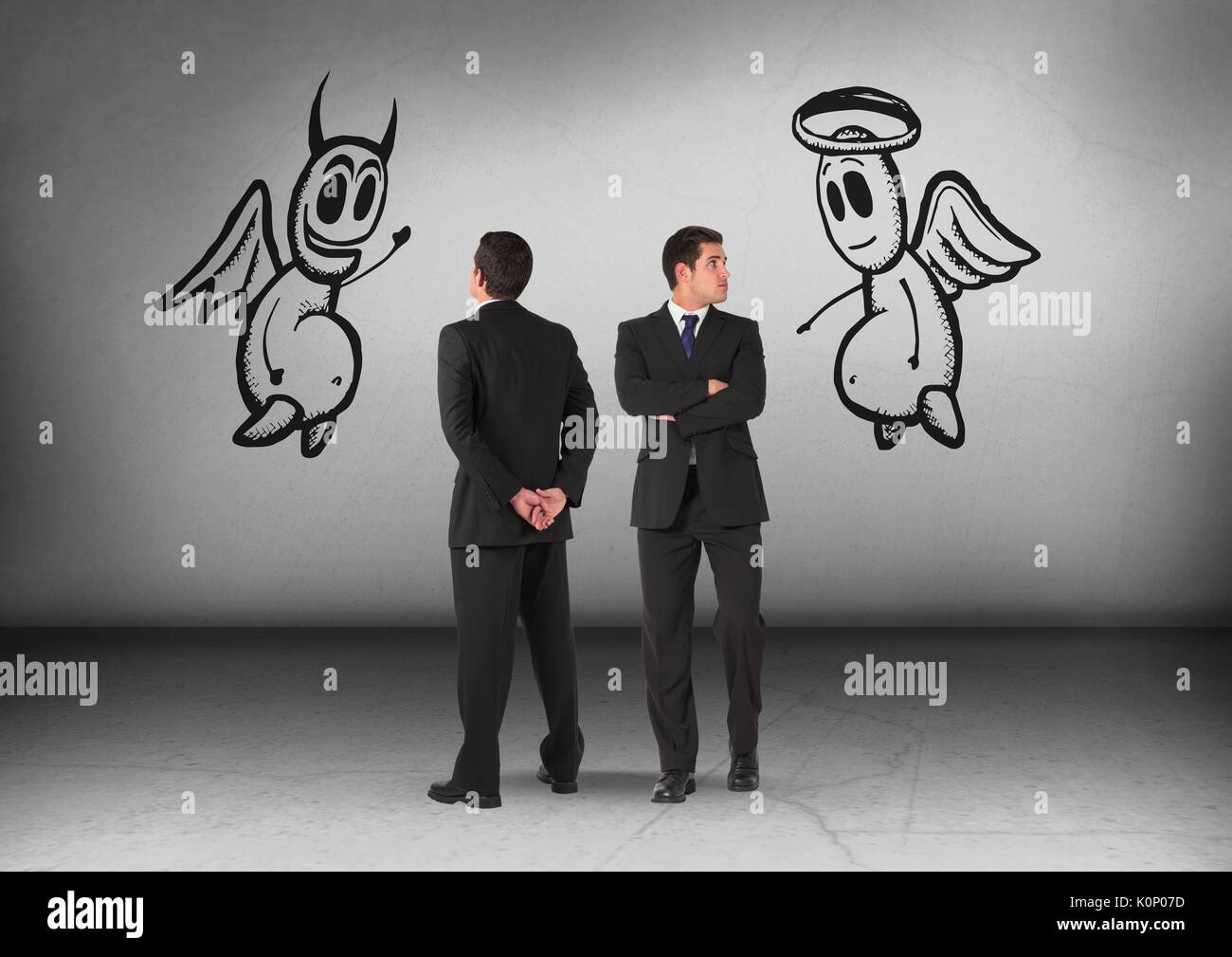 Digital composite of Good and evil graphics with Businessman looking in ...