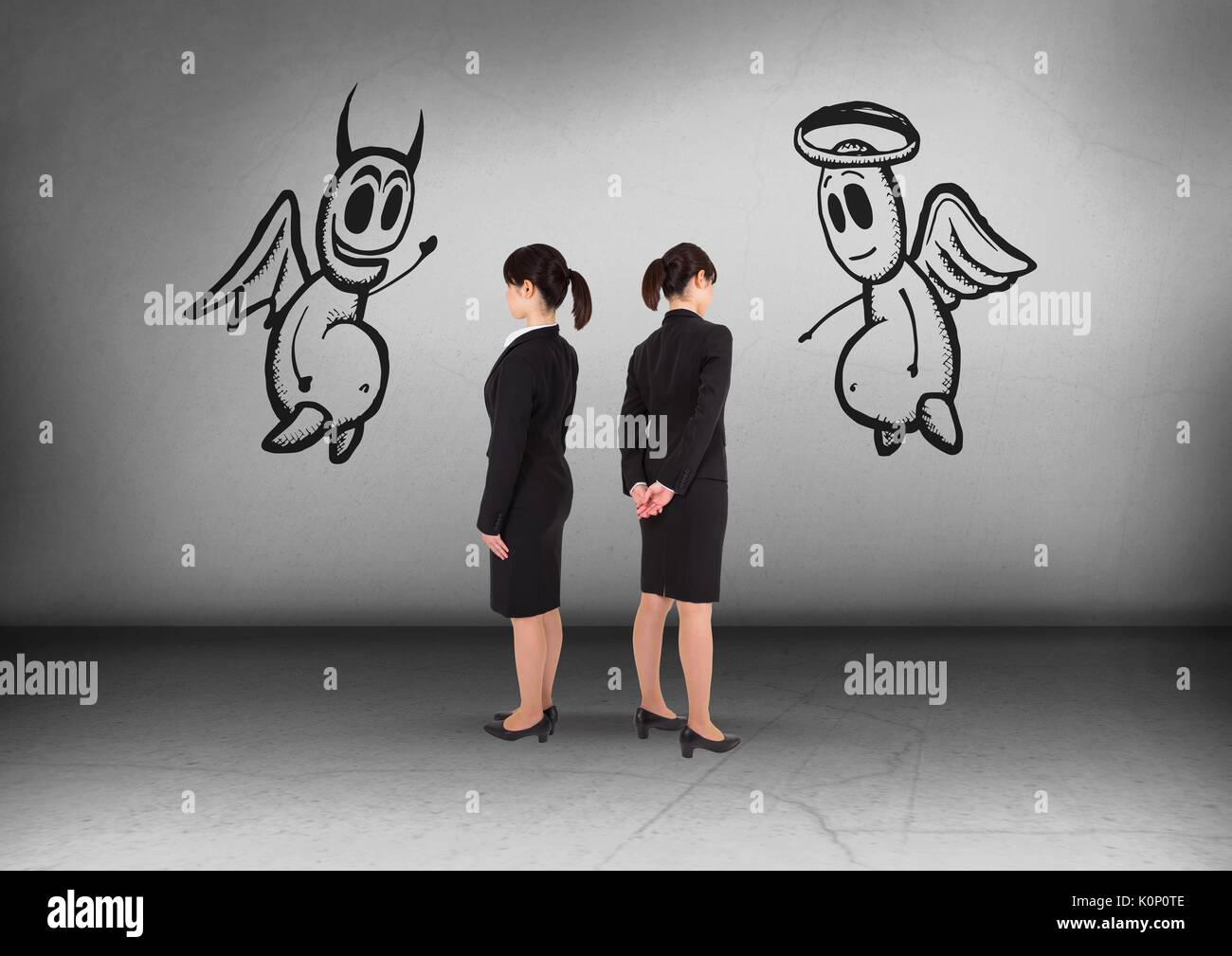 Digital composite of Good and evil graphics with Businesswoman looking ...