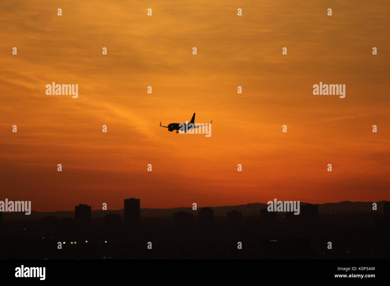 Plane in orange sunset Stock Photo - Alamy