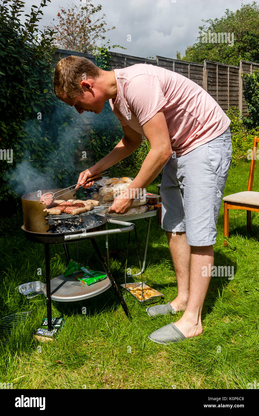 A Young Man Cooking Food On A Barbecue, Sussex, UK Stock Photo - Alamy