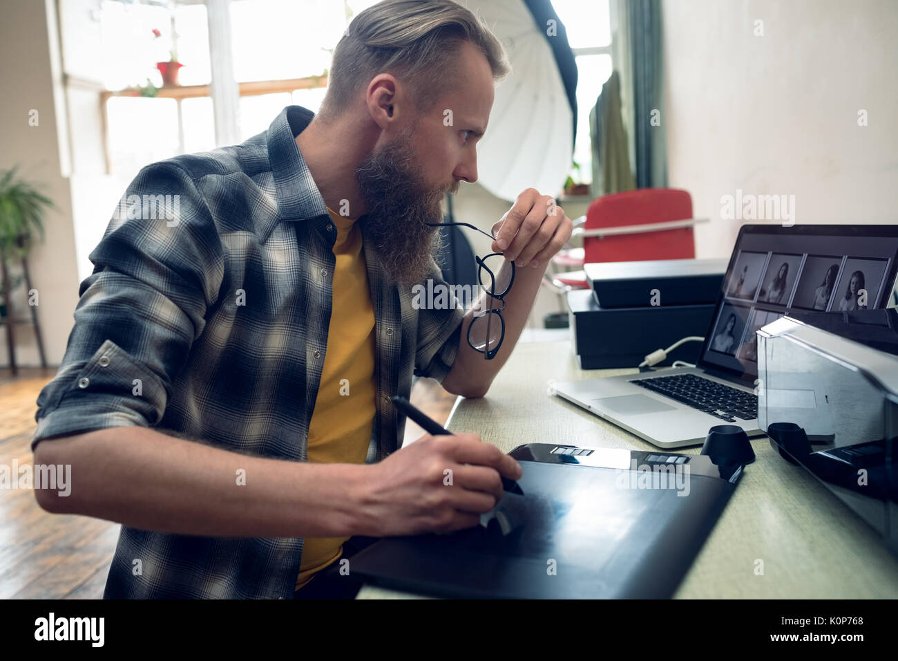 Photographer using graphic tablet while editing picture Stock Photo - Alamy