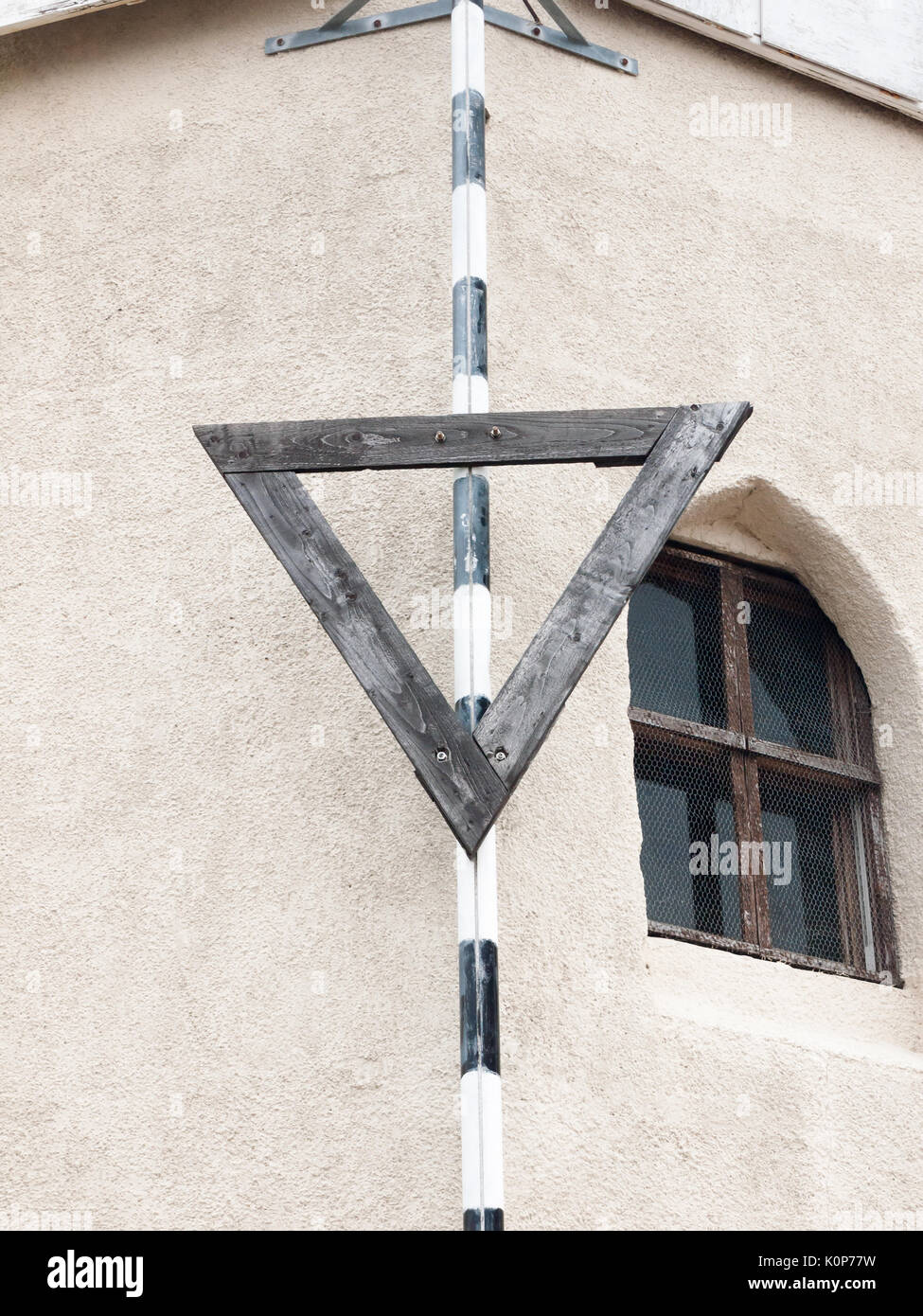 an upside down black triangle sign on pole seafront; England; UK Stock ...