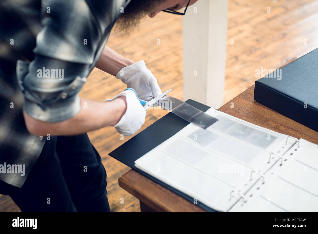 High angle view of photographer cutting film reel while working in ...