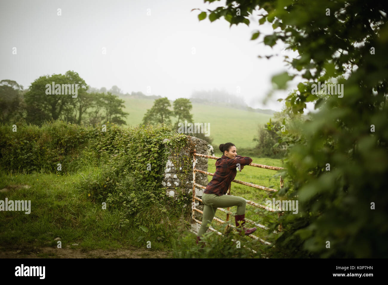 Woman leaning on gate hi-res stock photography and images - Alamy