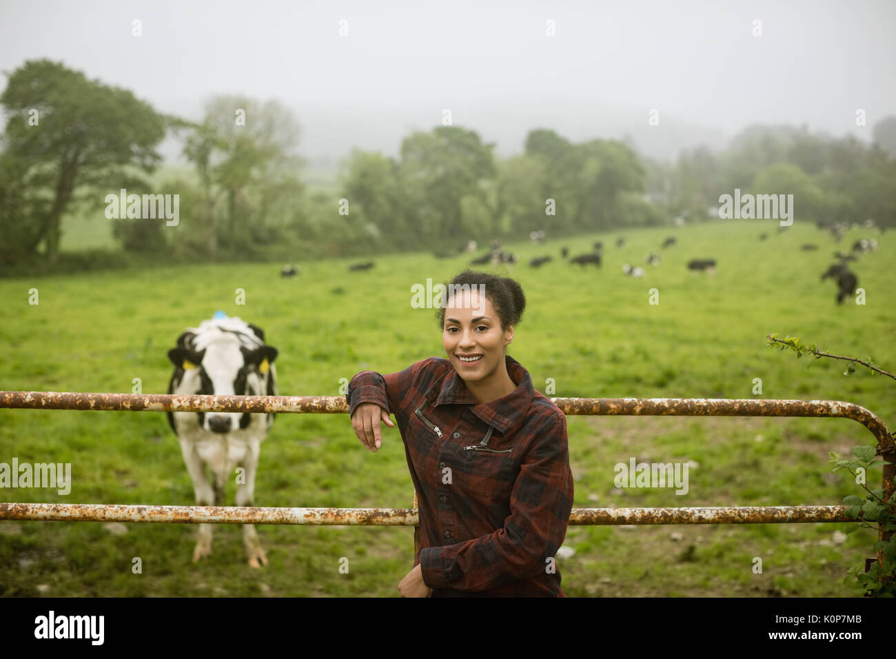 Happy woman standing in field cattle hi-res stock photography and ...