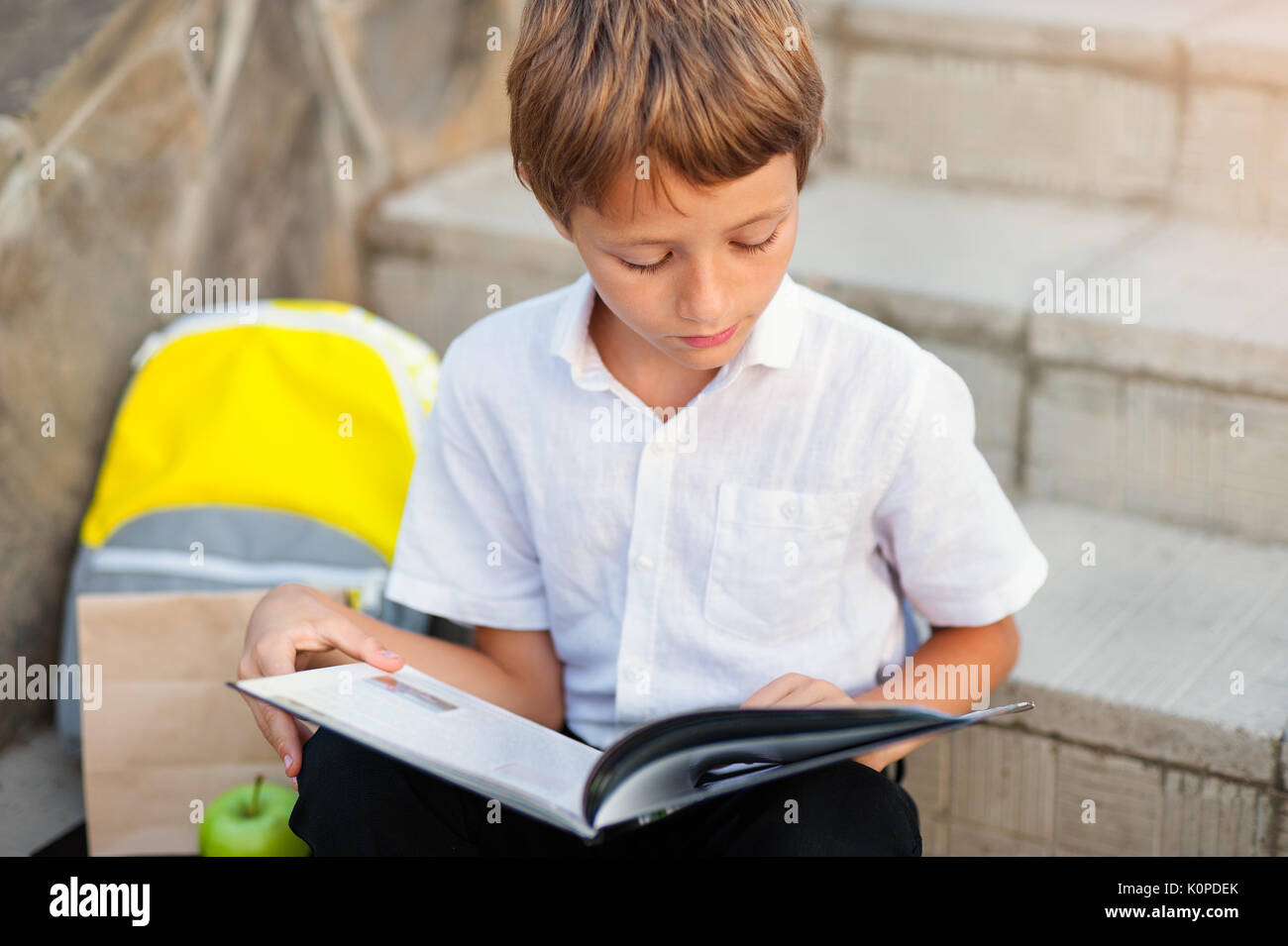 Child doing his homework outdoors after school Stock Photo - Alamy