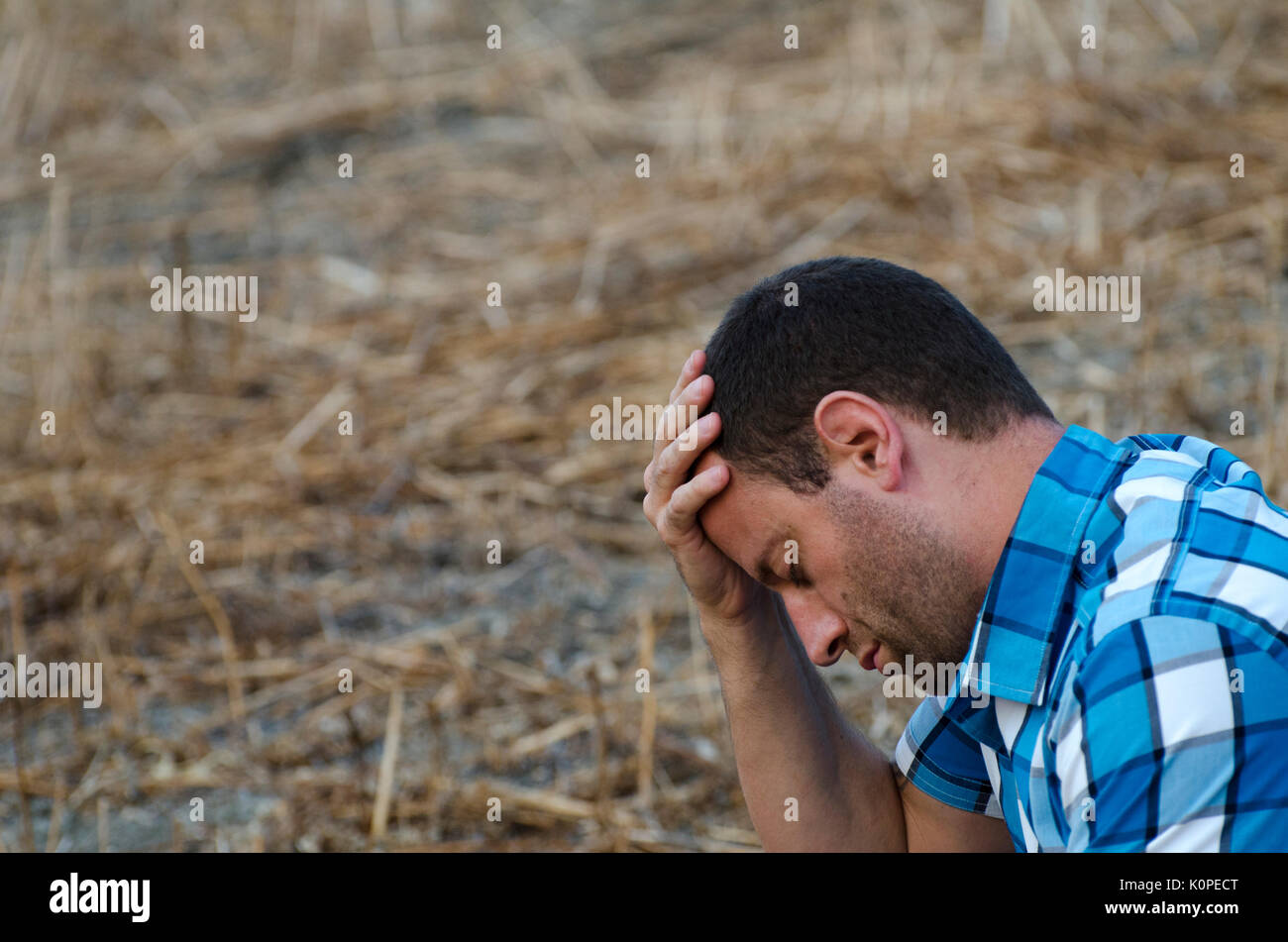 Man thinking with head down Stock Photo - Alamy