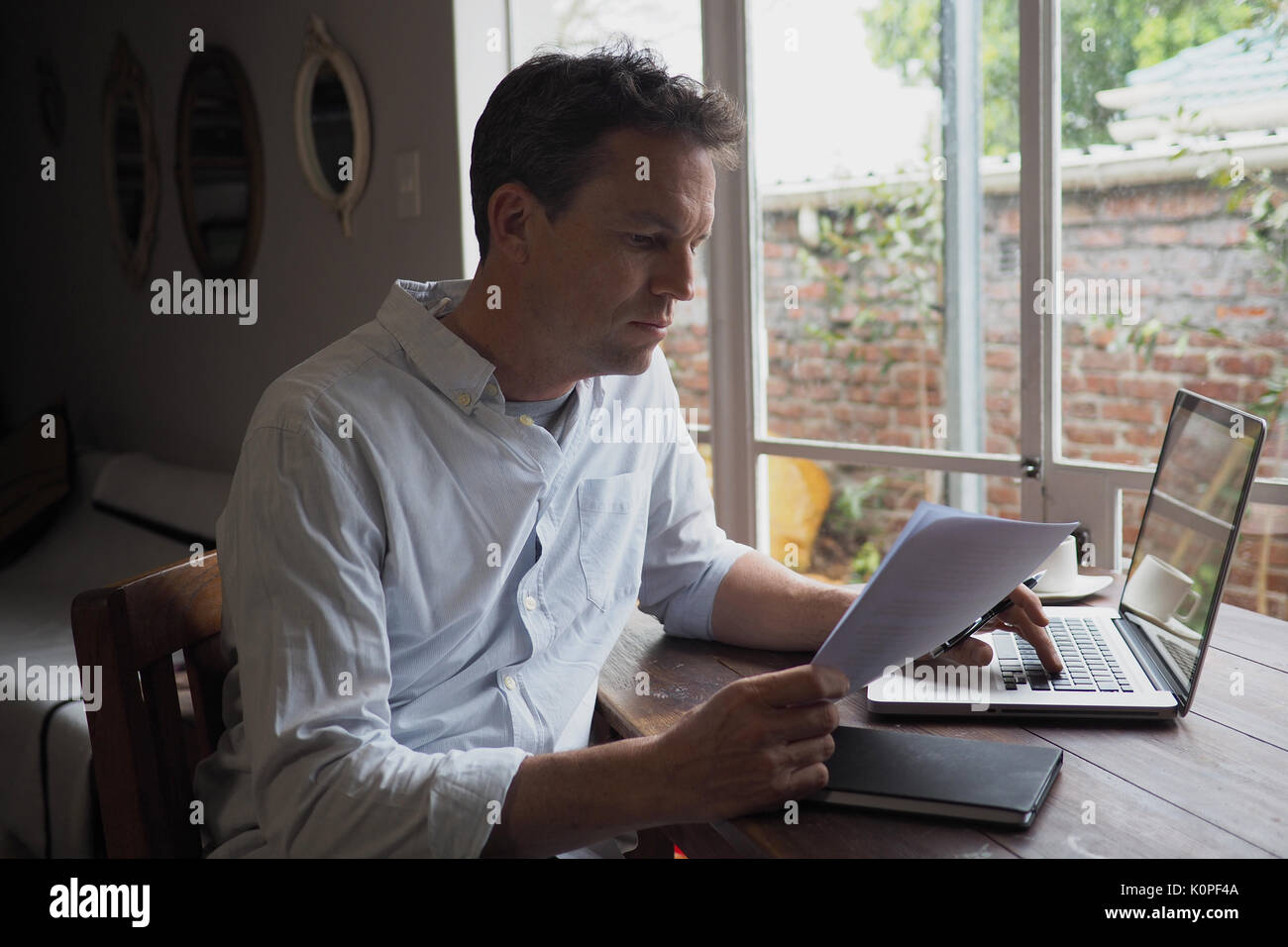 Professional man sitting desk reading hi-res stock photography and ...