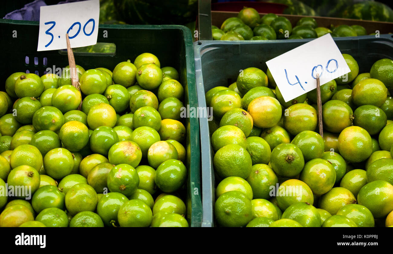 Green lemons in the local market with price tags Stock Photo - Alamy