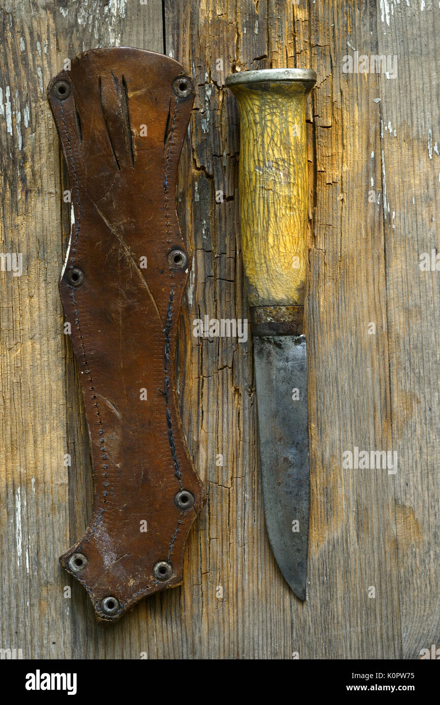 traditional Finnish knife puukko and sheath on a wooden background ...