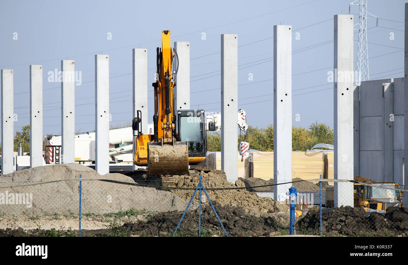 new factory construction site with excavator Stock Photo - Alamy