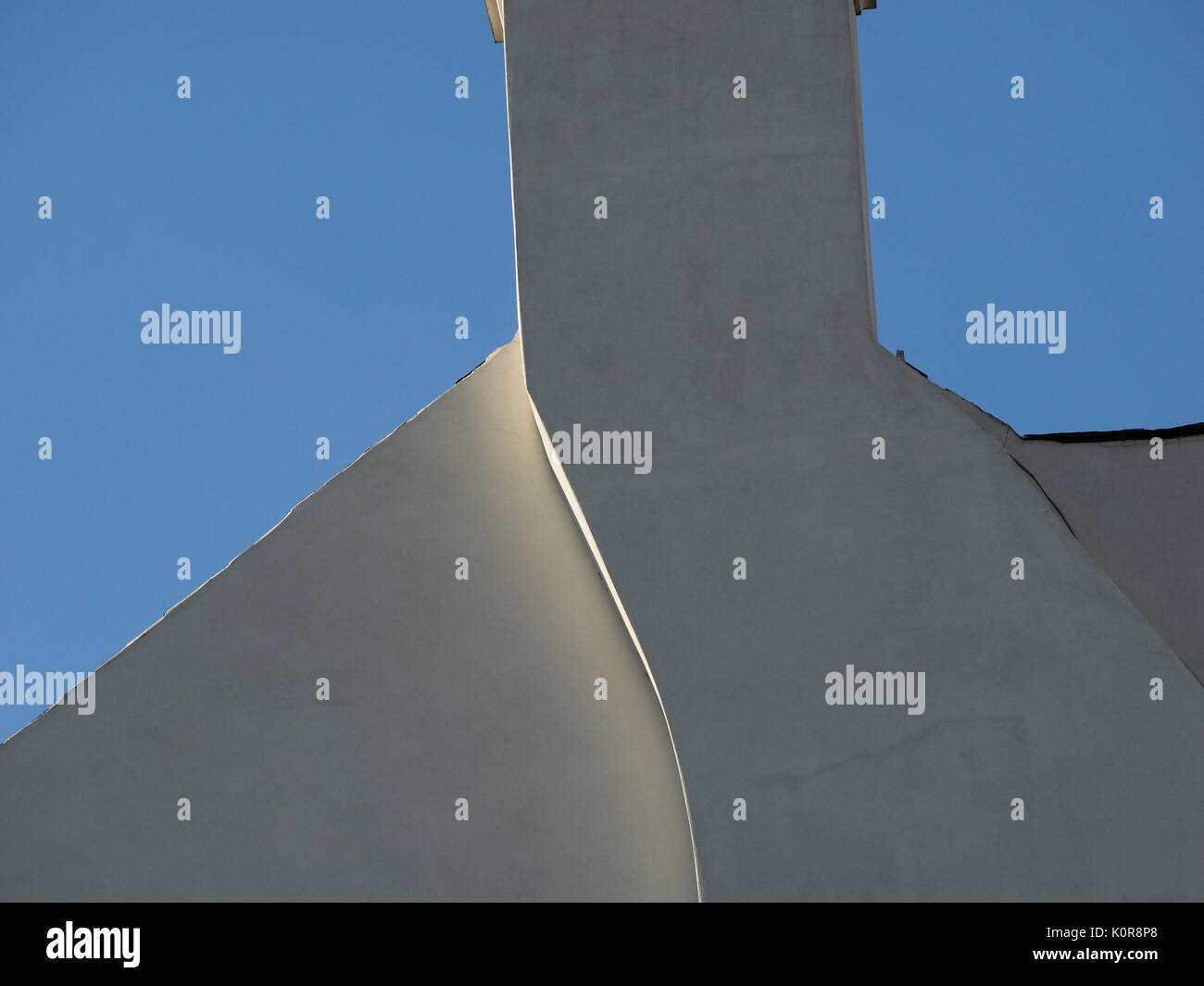 strip of sunshine catches the curve of a chimney stack on the white ...