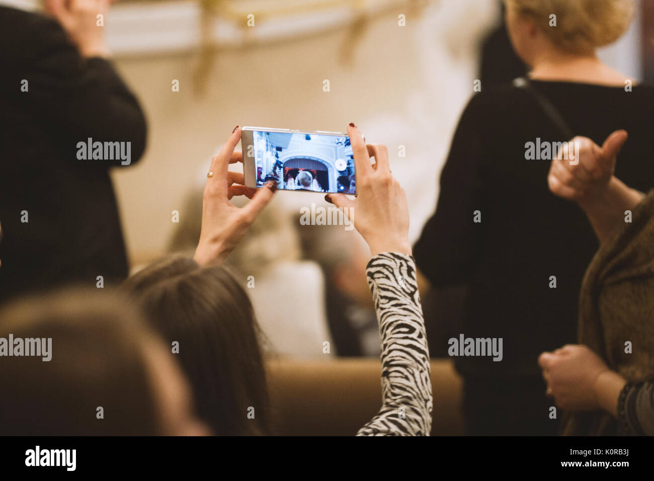 Spectators at concert - people shooting performance on smartphone ...
