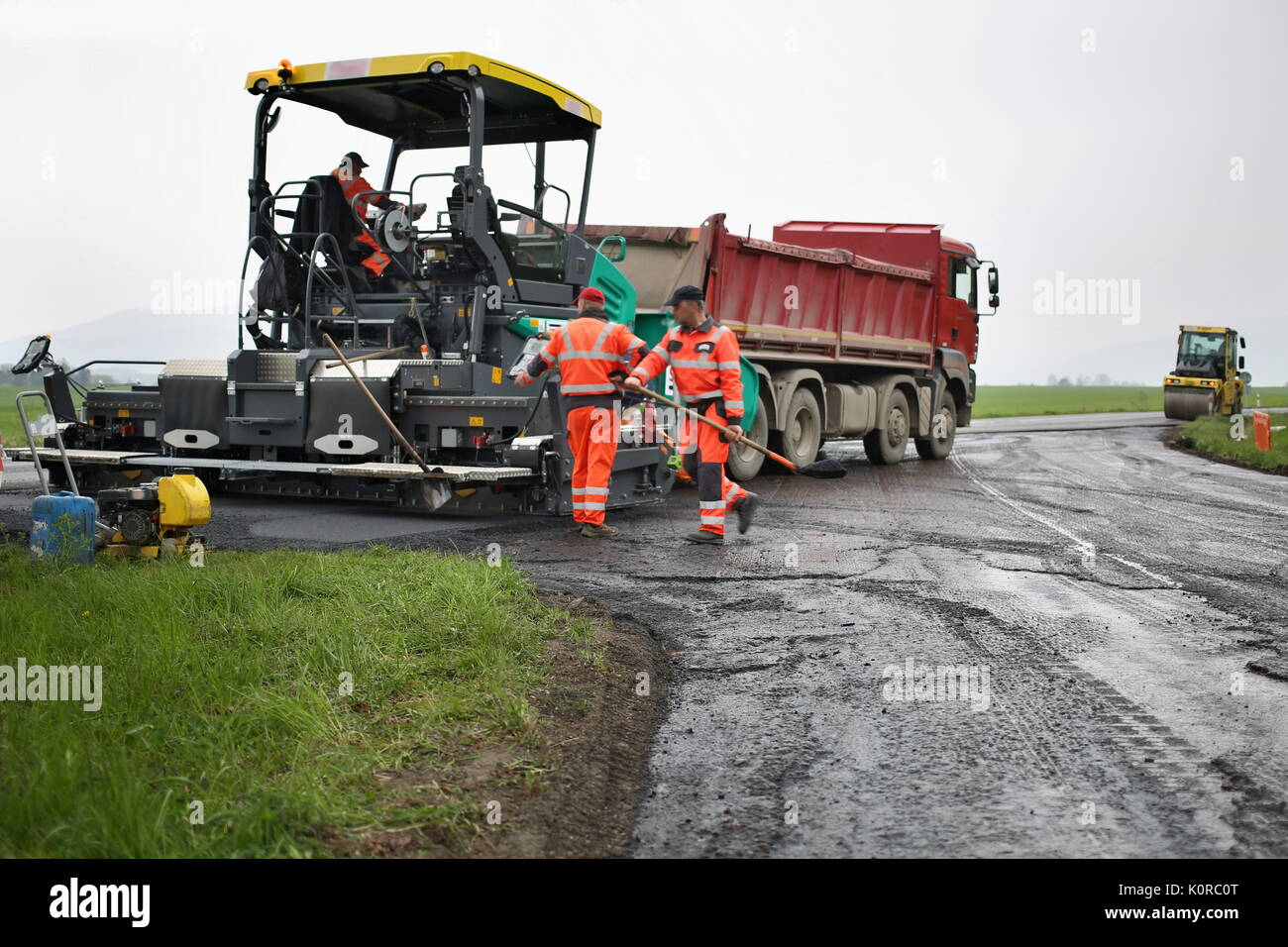 Tractor, roller , truck on the road repair site. Road construction ...