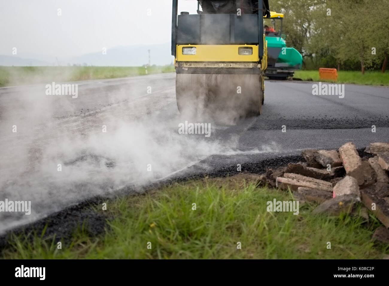 Tractor, roller , truck on the road repair site. Road construction ...