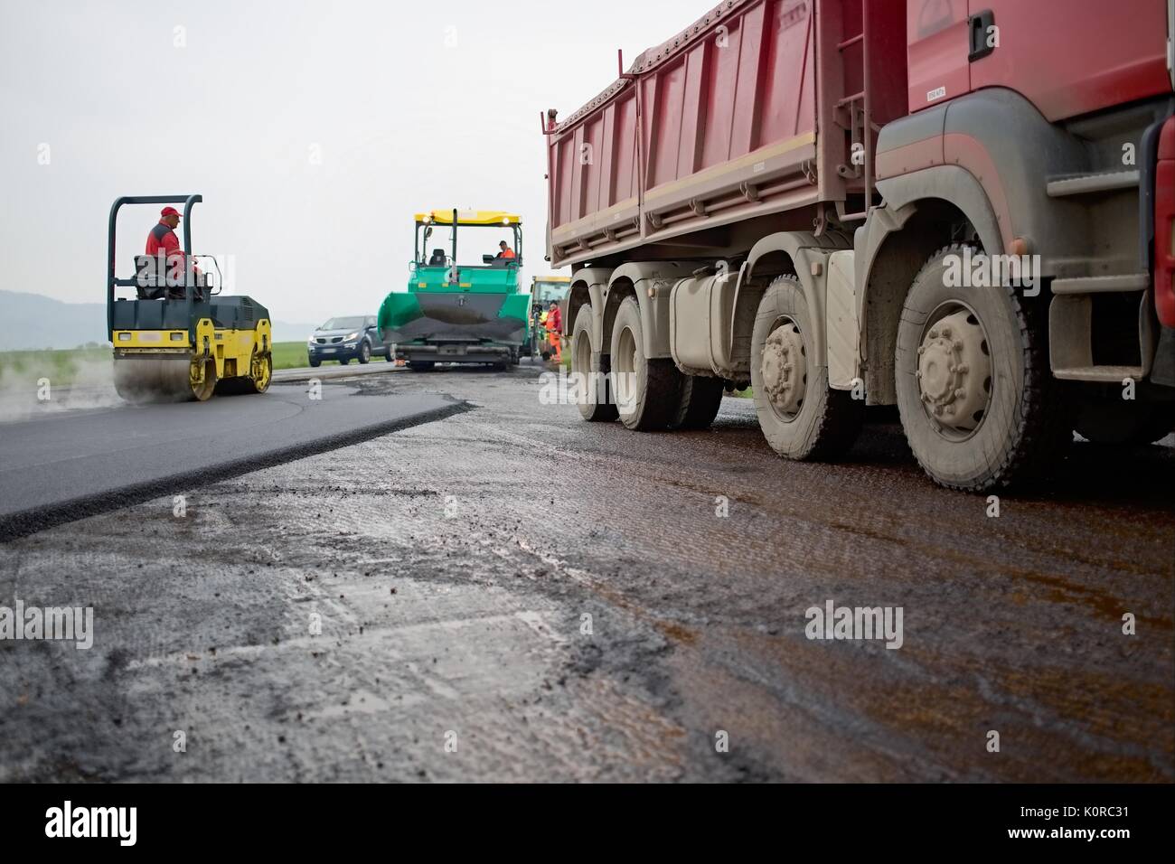 Tractor, roller , truck on the road repair site. Road construction ...
