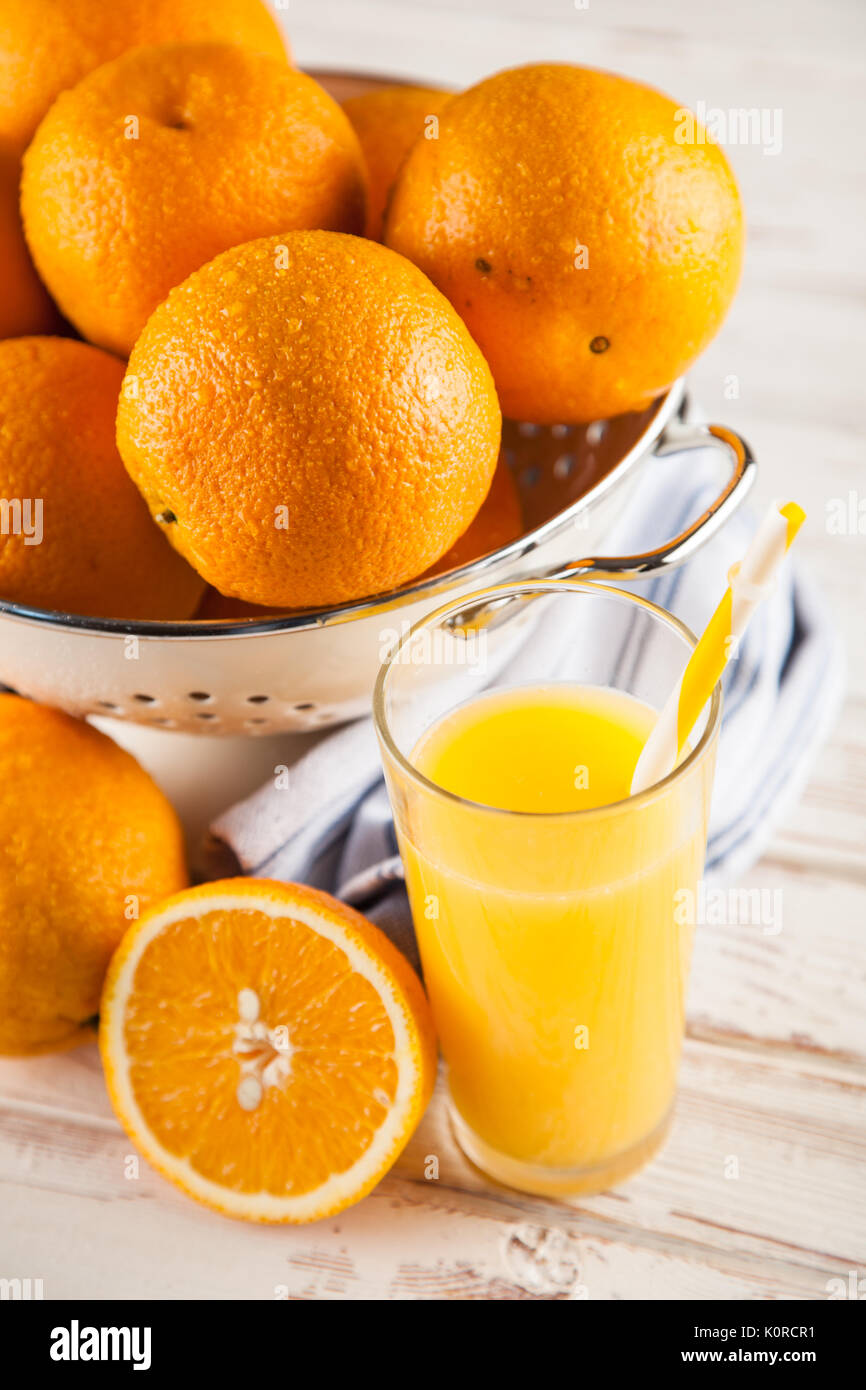 A glass of fresh orange juice with a straw hi-res stock photography and ...